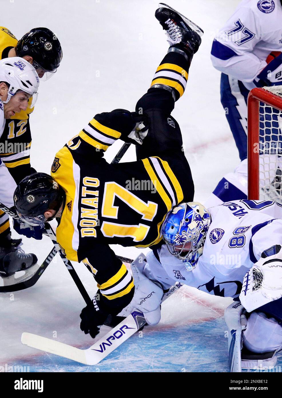Boston Bruins center Ryan Donato (17) is upended as he collides with ...