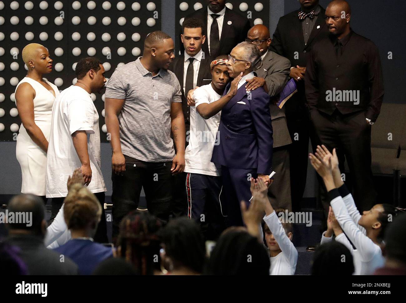 Rev. Al Sharpton, center right, hugs Stevante Clark during the funeral ...