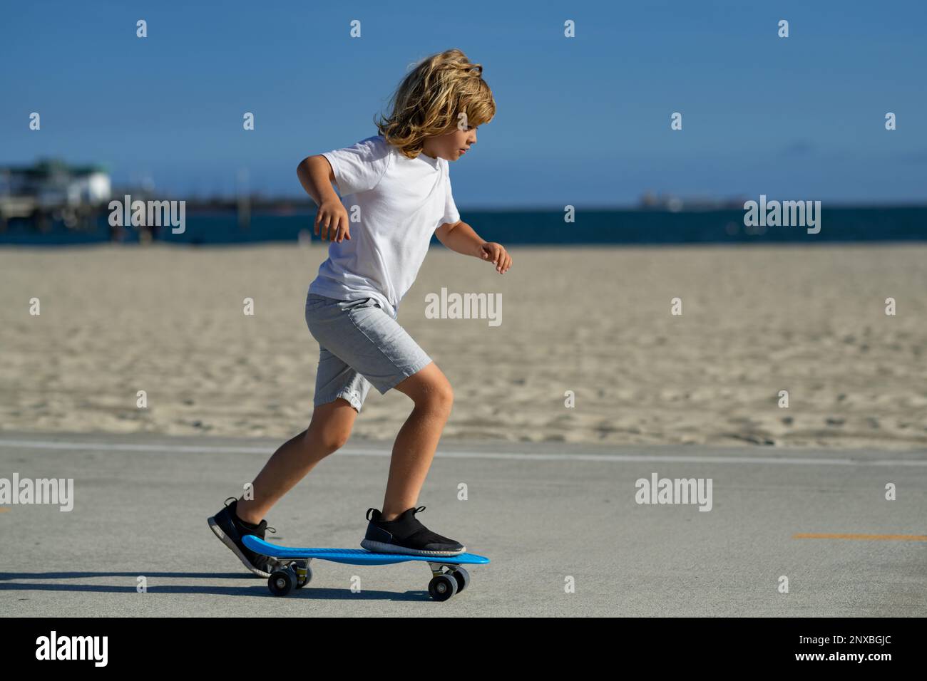 Child skateboarding at park in the city. Kid boy enjoy and having fun ...