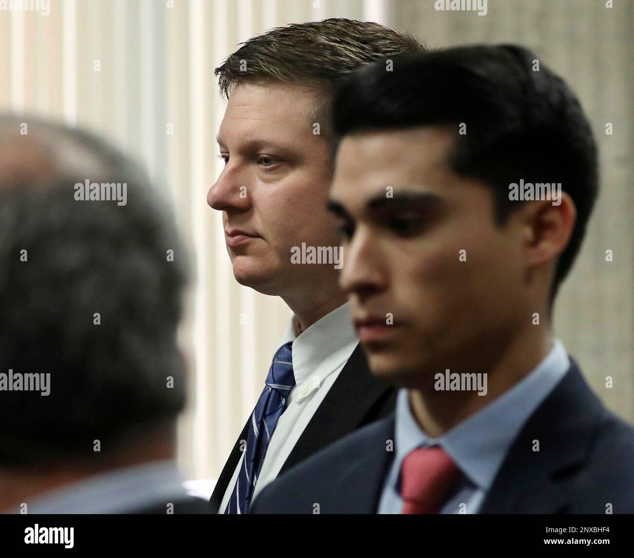 Chicago Police Officer Jason Van Dyke, center, stands in front of Judge ...