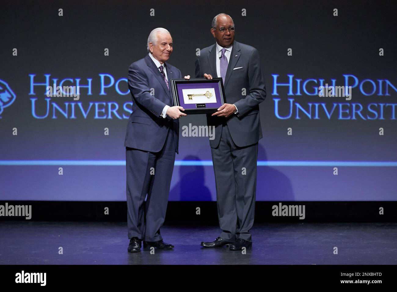 High Point University President Dr. Nido Qubein (left) presents the key ...