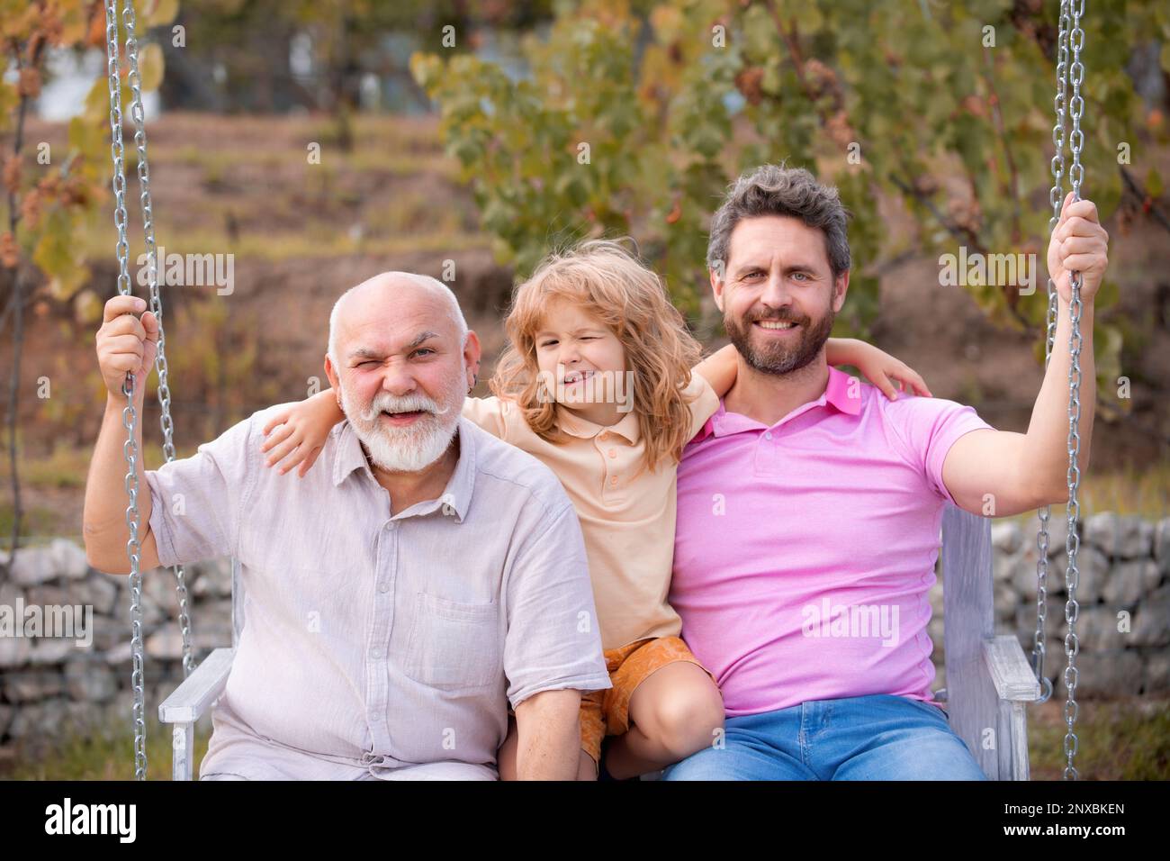 Men generation: grandfather father and grandson are swinging, looking ...