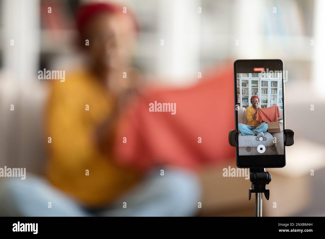 Selective focus on cell phone recording black woman influencer Stock ...