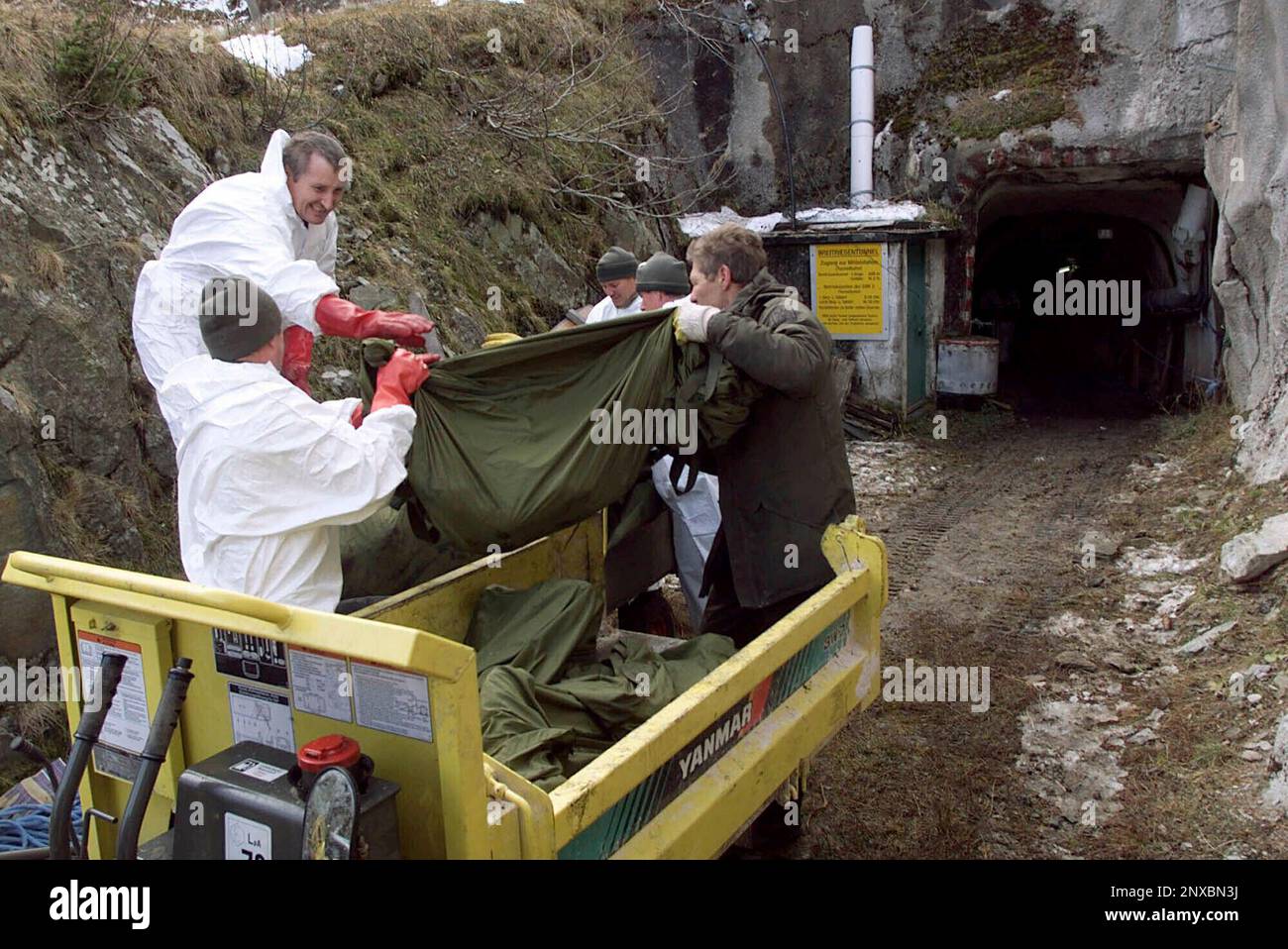 FILE - Experts load body bags next to a service tunnel that connects to ...