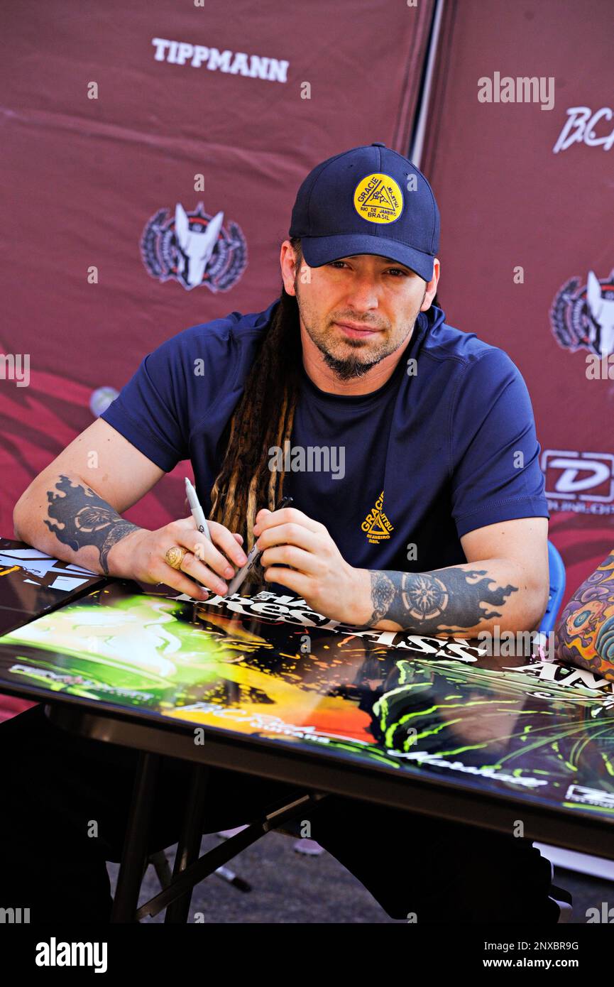 Zoltan Bathory of Five Finger Death Punch signs autographs during the ...