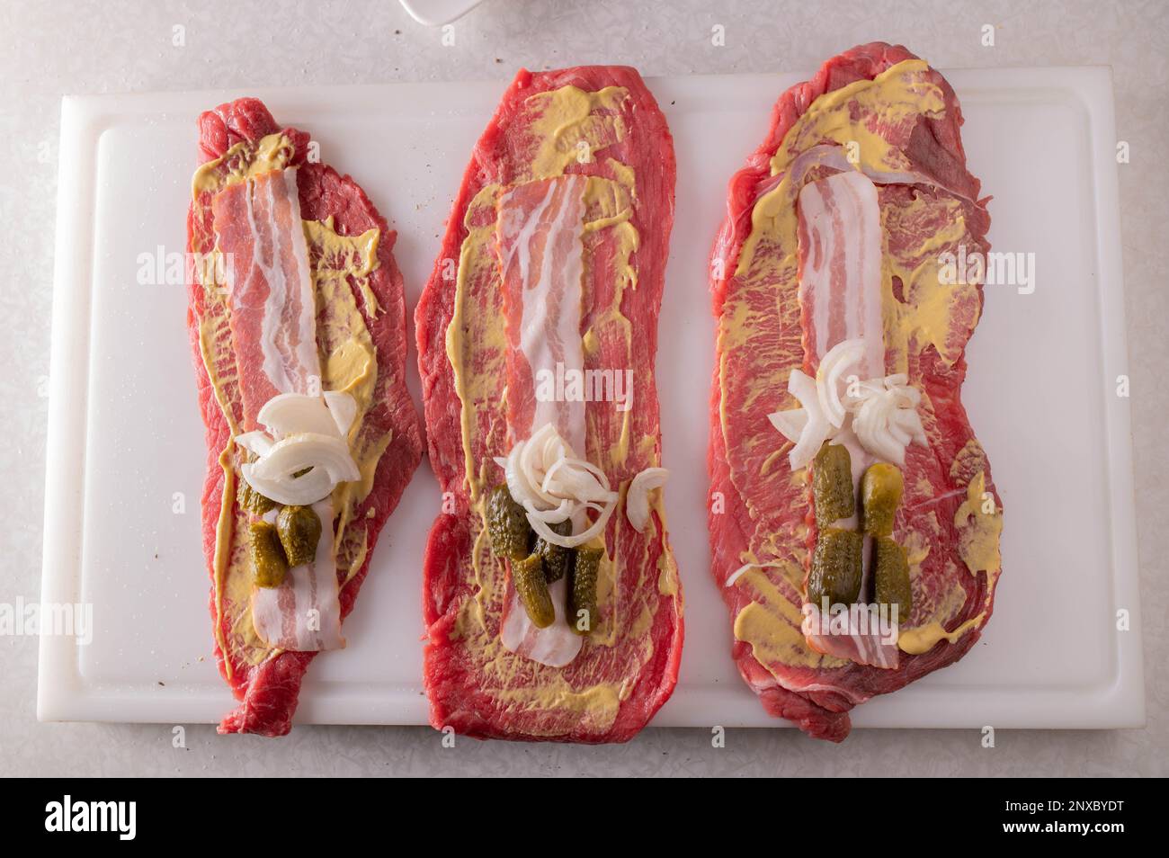 German beef roulades cooking, making, preparation. Filling with mustard ...