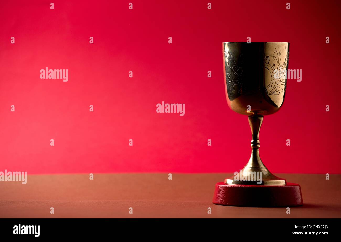 golden chamice and red backgroundgolden Stock Photo - Alamy