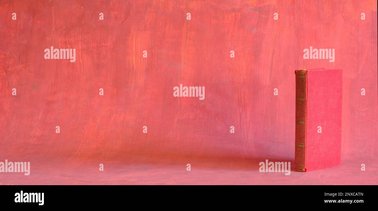 Single red book in front of a red background, reading,education ...