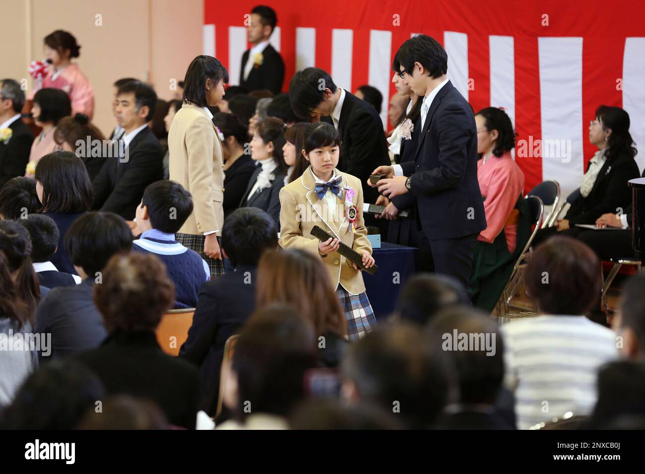 Elementary school's students attend a graduation ceremony in Nerima ...