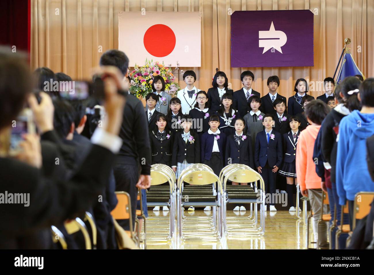 Elementary school's students attend a graduation ceremony in Nerima ...