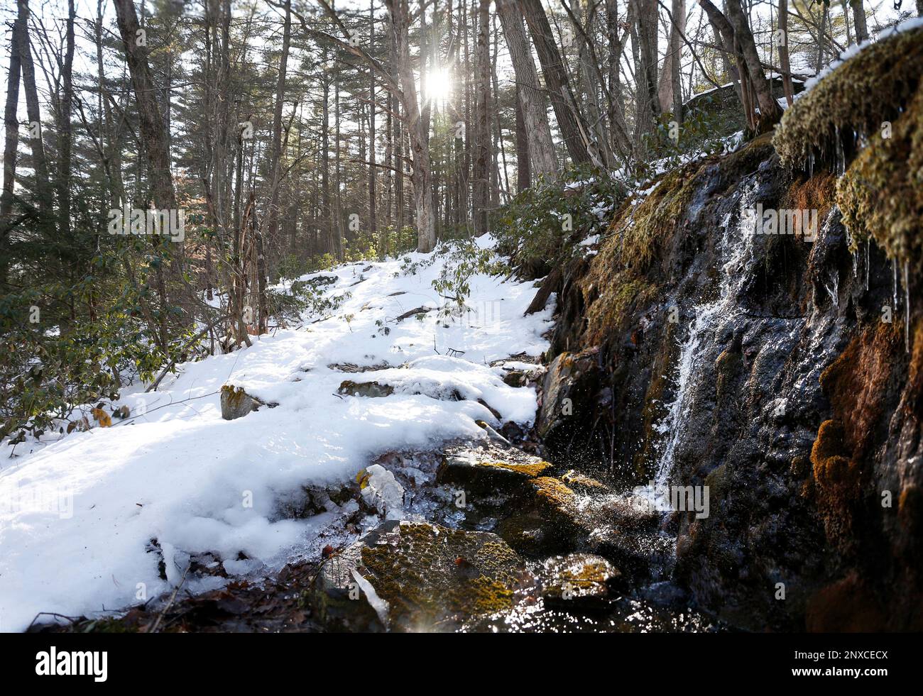 In this Saturday, March 17, 2018 photo, a small waterfall cascades ...