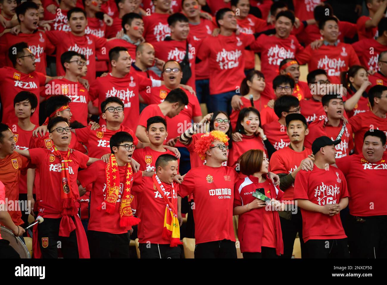 Chinese fans shout slogans to show their support for Chinese national ...