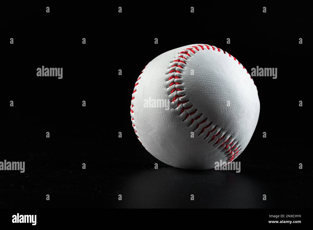 Baseball game equipment on dark black background Stock Photo - Alamy