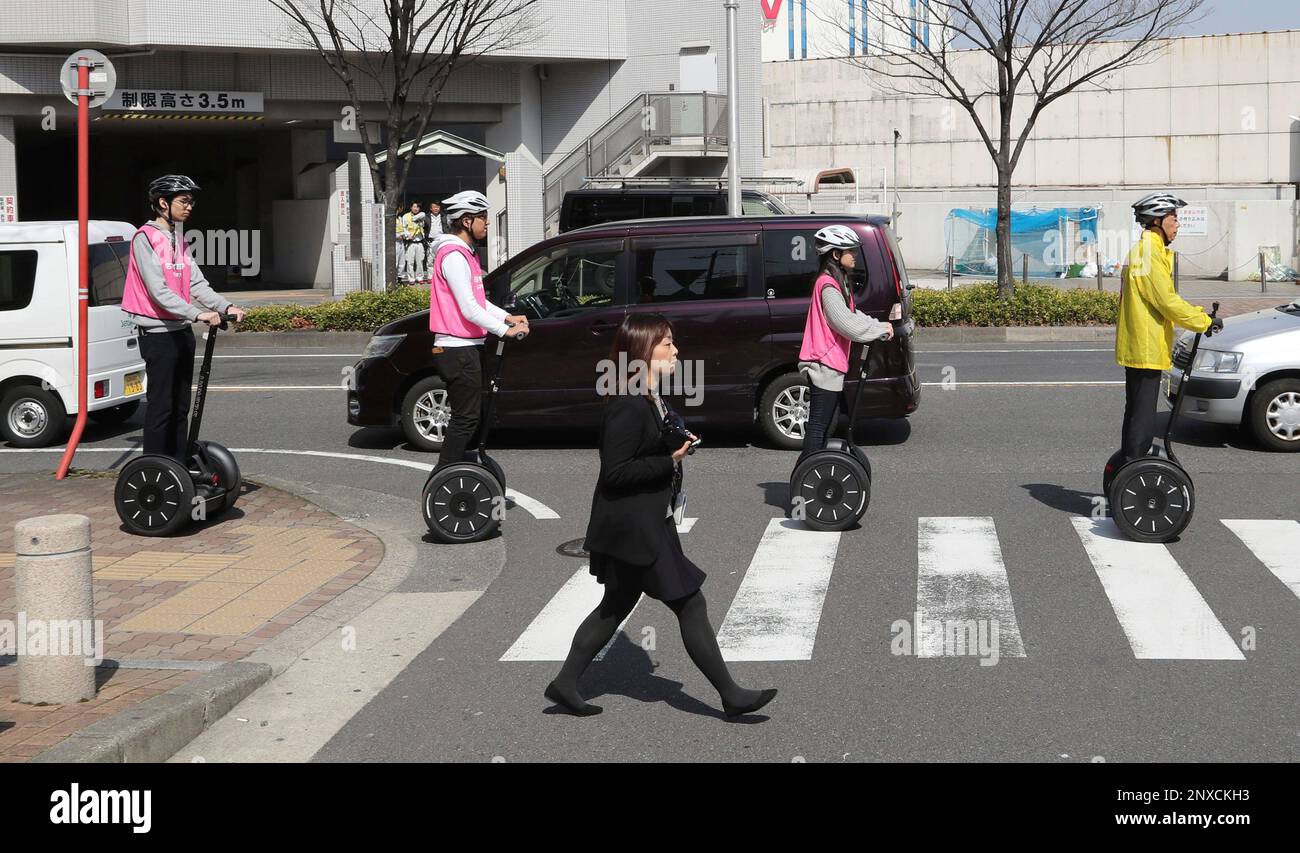 People ride segways in Nagoya, Aichi Prefecture on March 13, 2018. A ...