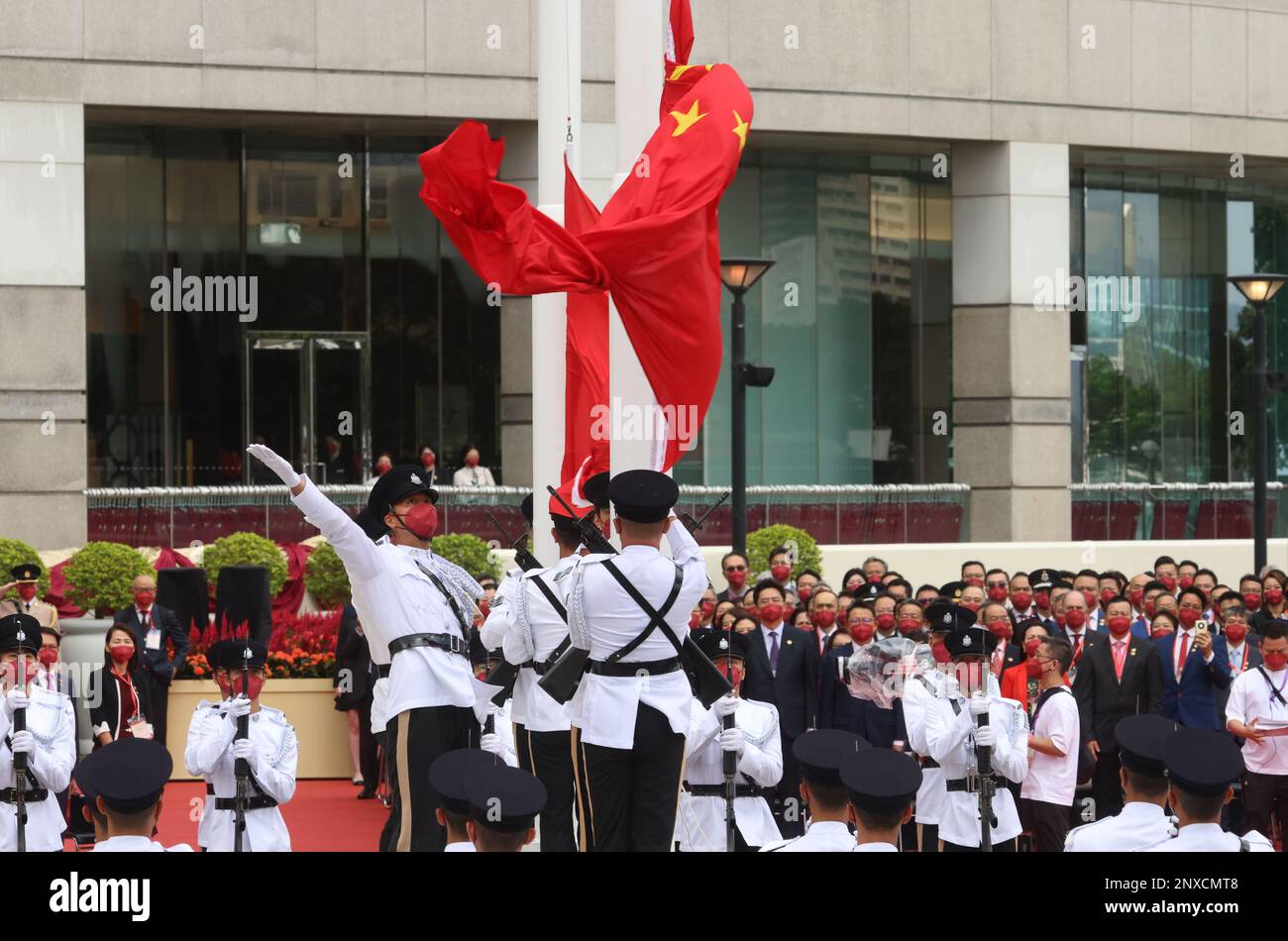 Flag-raising ceremony at Golden Bauhinia Square and officiates at a ...