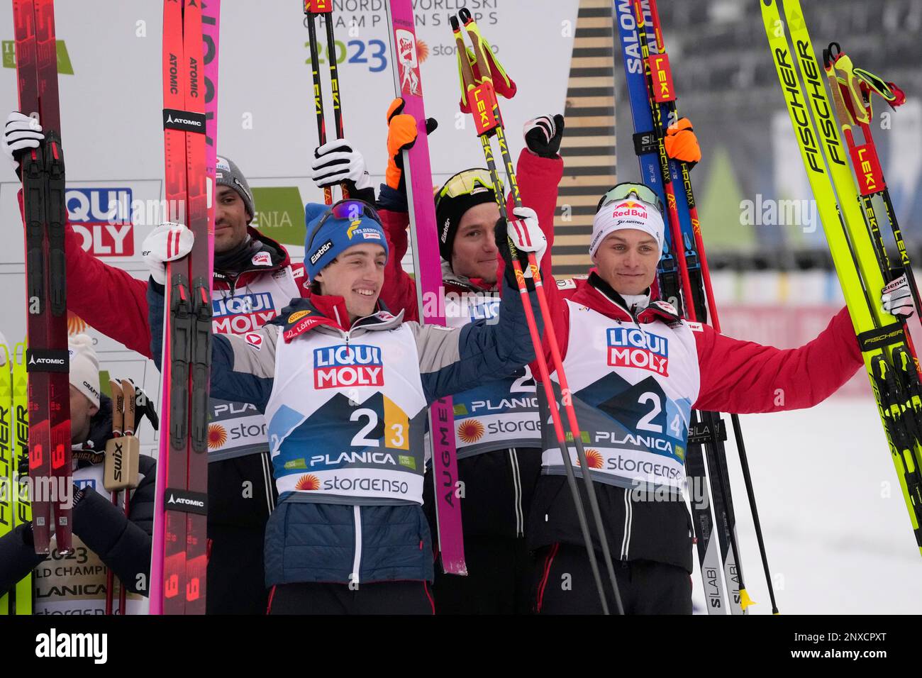 Austrian athletes celebrate on the podium after winning the bronze ...