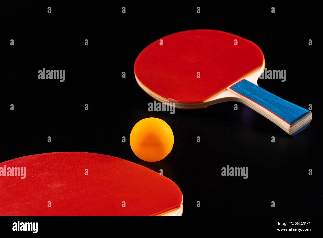 Red ping pong racket on dark background Stock Photo - Alamy