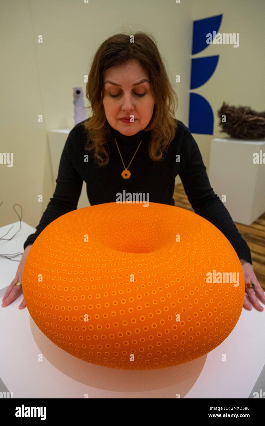 London, UK. 1 March 2023. A staff member presents "Marigold Bindhu form ...