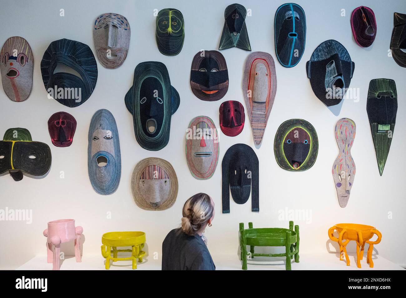 London, UK. 1 March 2023. A staff member views textile tribal masks by ...