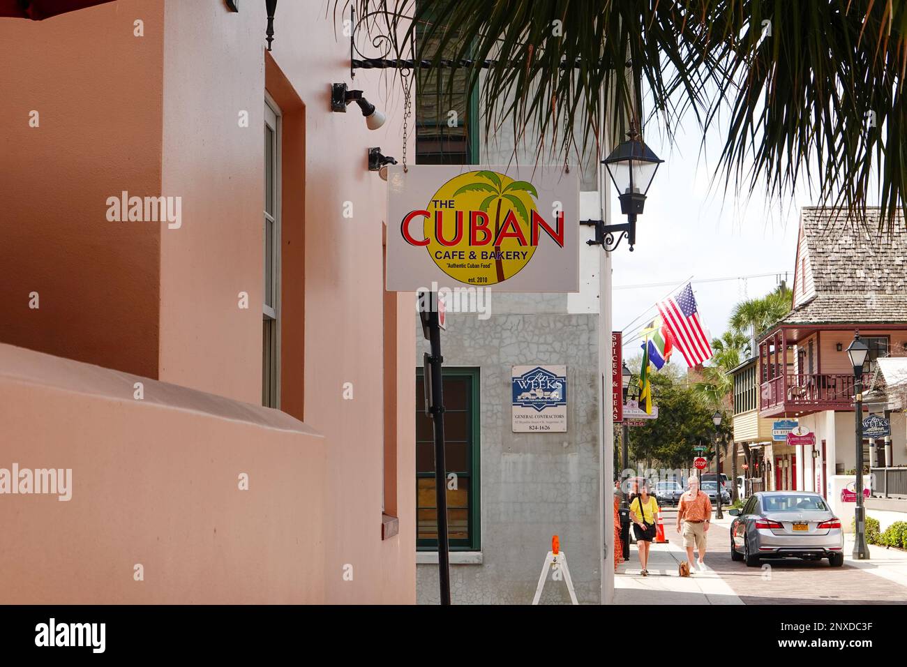 Sign for The Cuban Cafe and Bakery, plus people on St. George St ...
