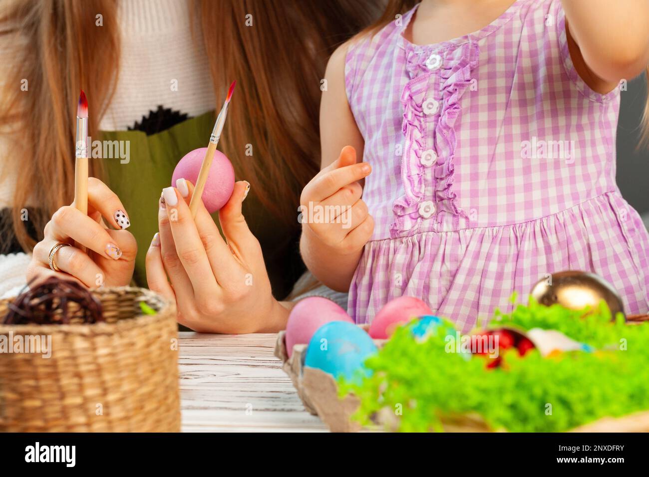 Mother and daughter coloring eggs for Easter Stock Photo - Alamy
