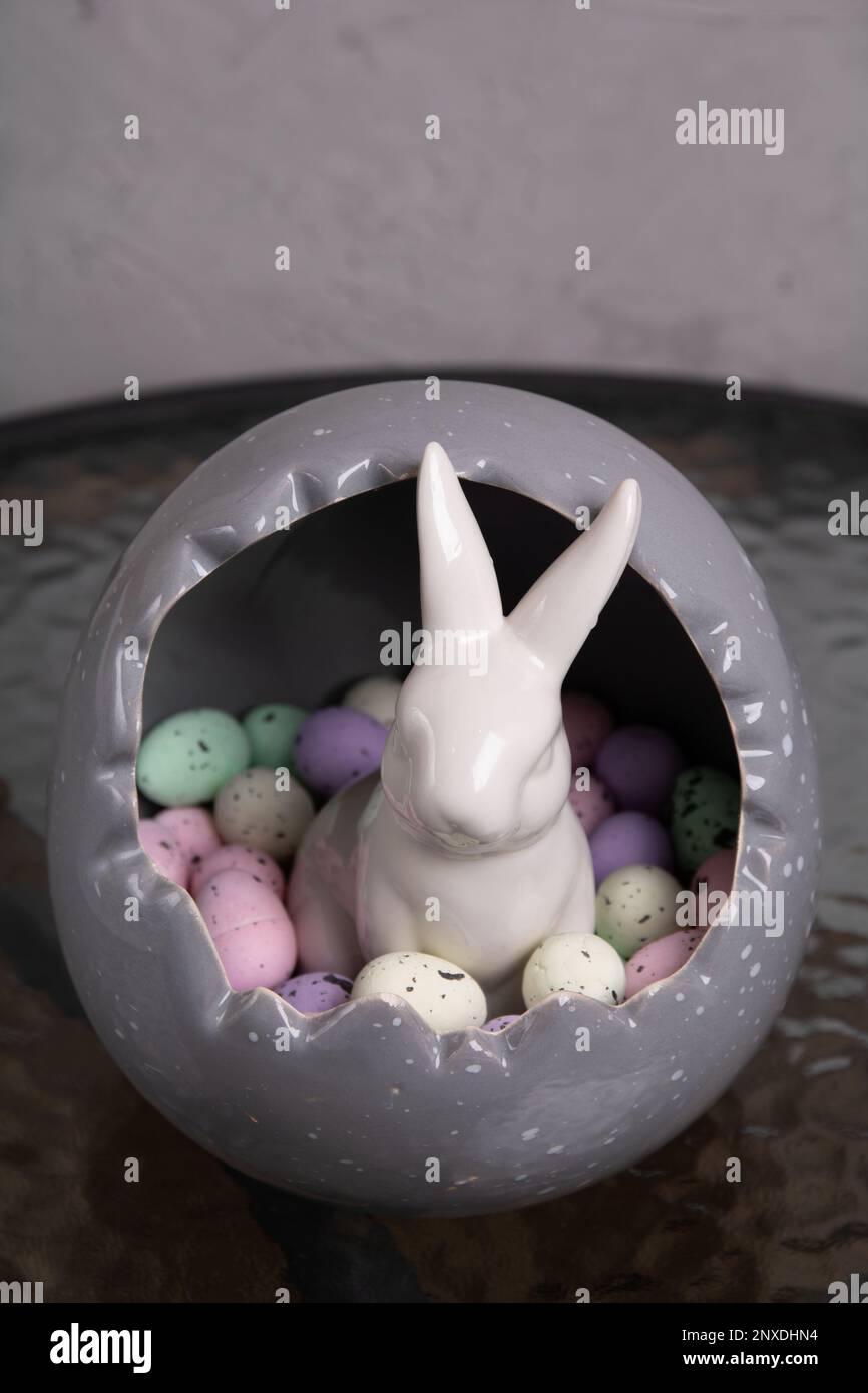 photo in a large gray egg lies a lot of colorful decorative small eggs ...