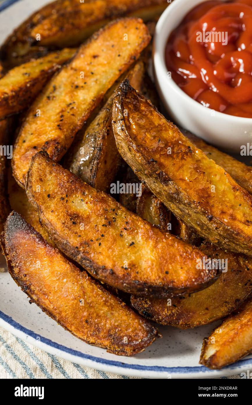 Homemade Cut Potato Wedge French Fries with Ketchup Stock Photo - Alamy