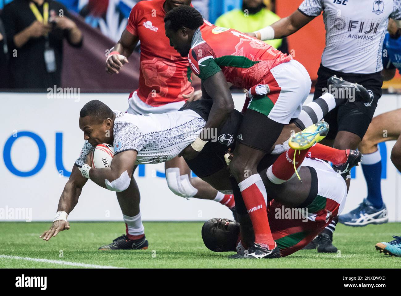 Fiji's Paula Dranisinukula, left, scores a try as Kenya's Collins ...