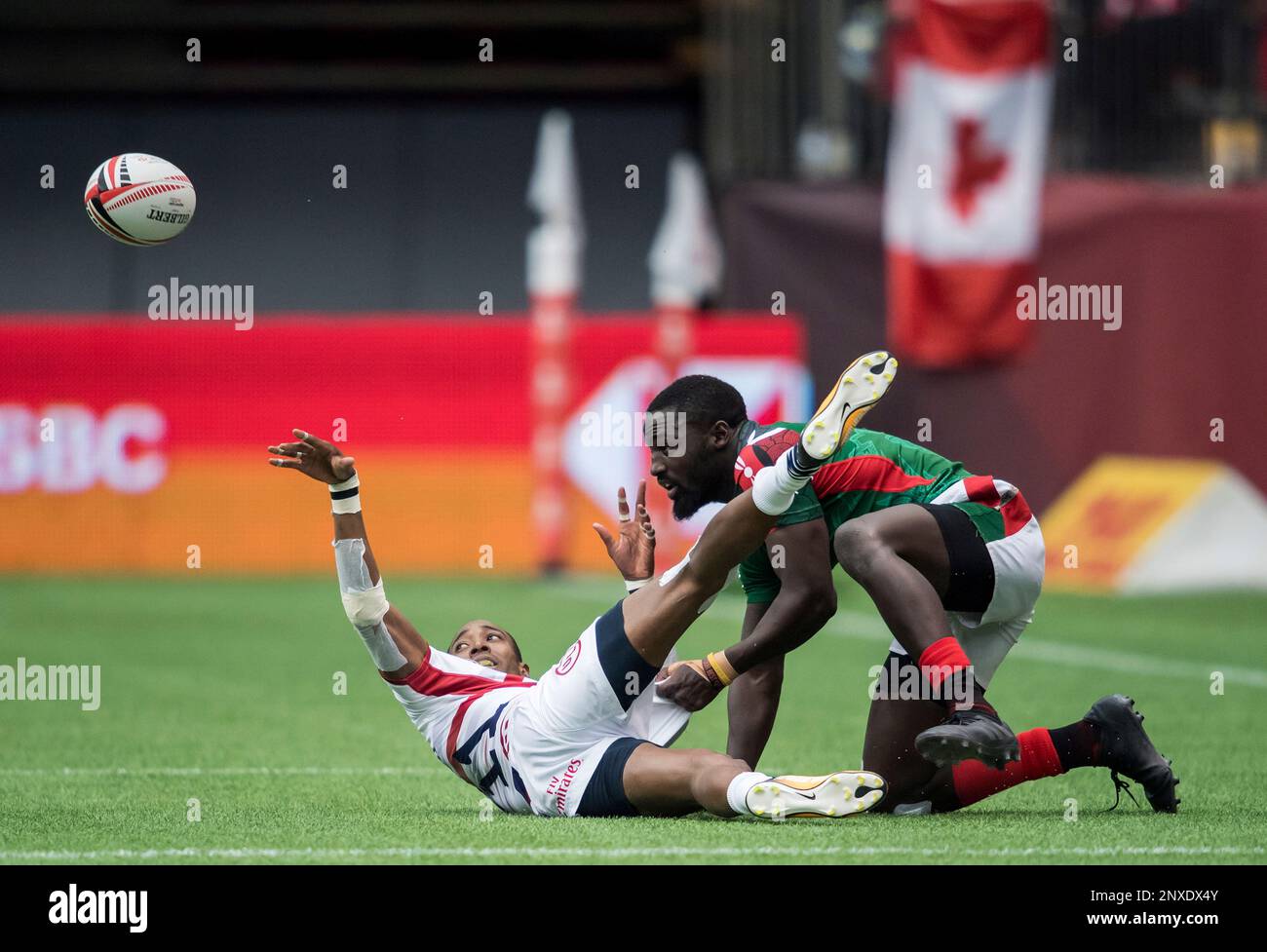 United States' Perry Baker, left, passes the ball after colliding with ...