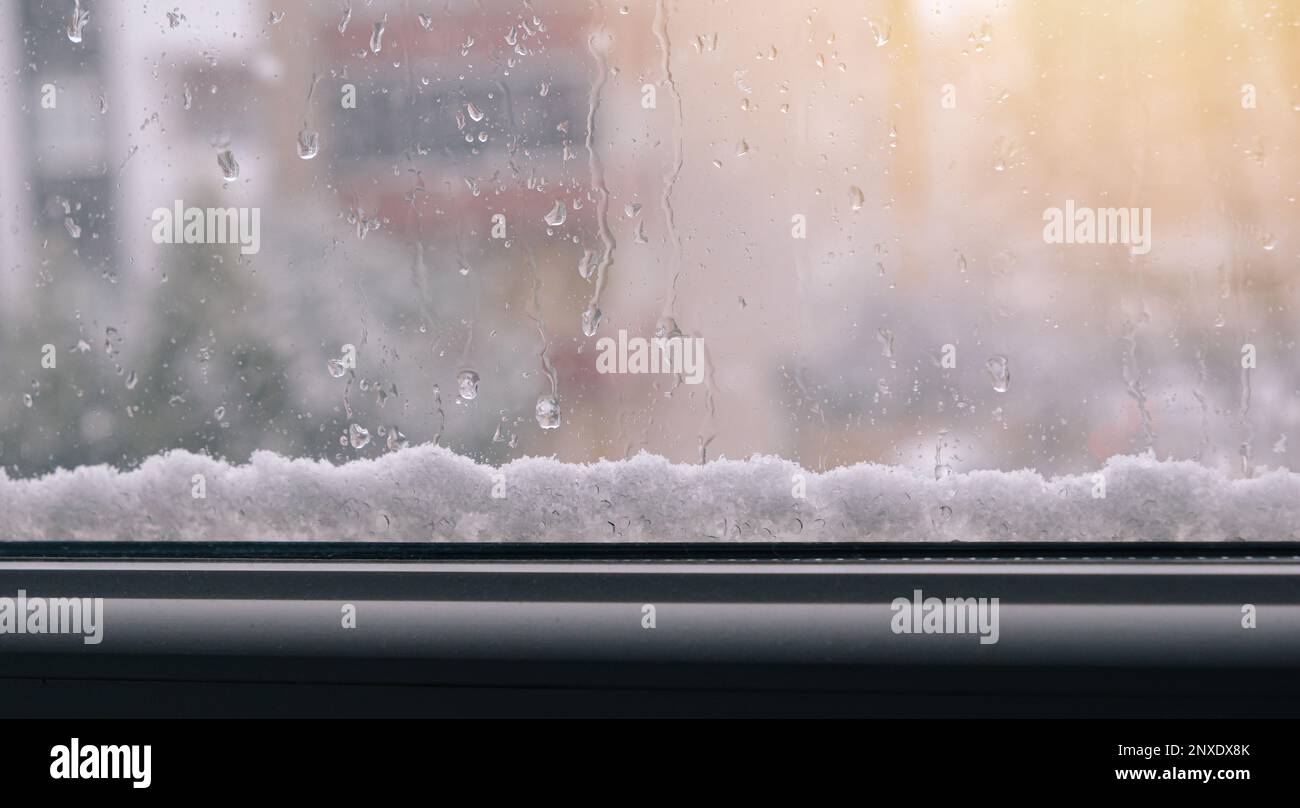 Frosted window with snow outside with sunrise background Stock Photo ...