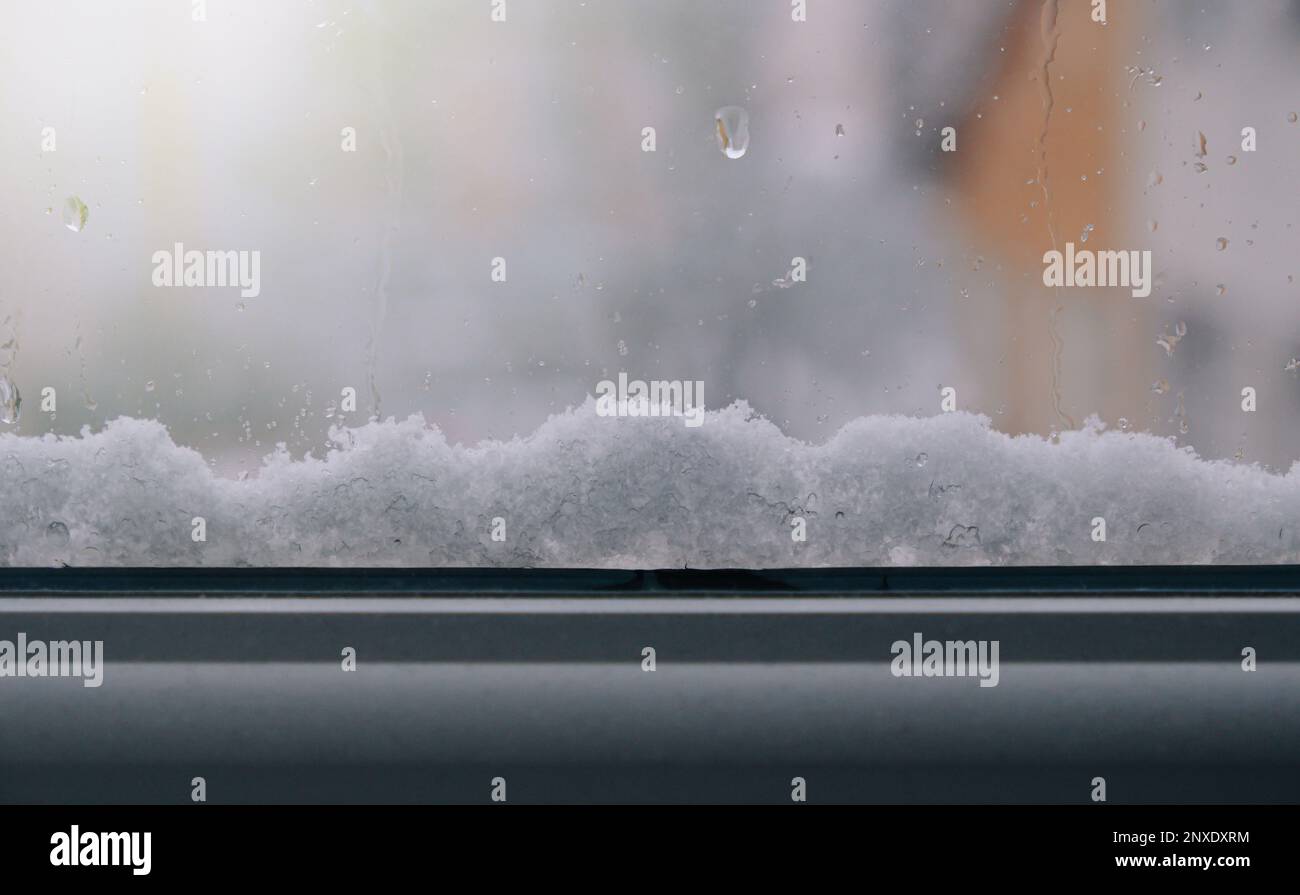 Frosted window with snow outside with sunrise background Stock Photo ...