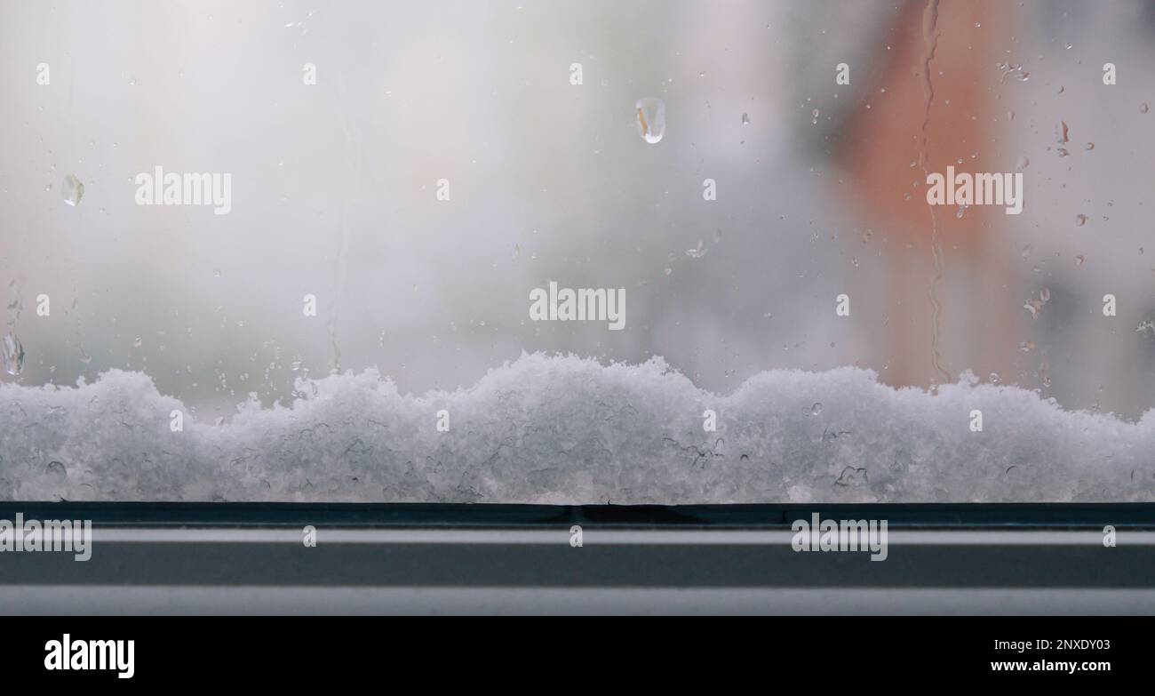 Frosted window with snow outside with sunrise background Stock Photo ...
