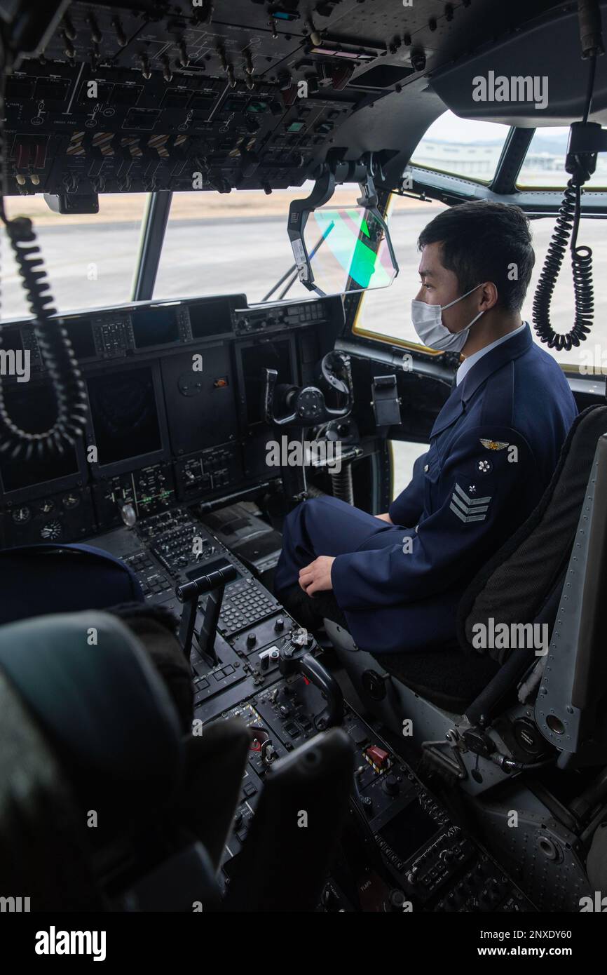 A Japan Air Self-Defense Force cadet sits in the cockpit of a KC-130J ...