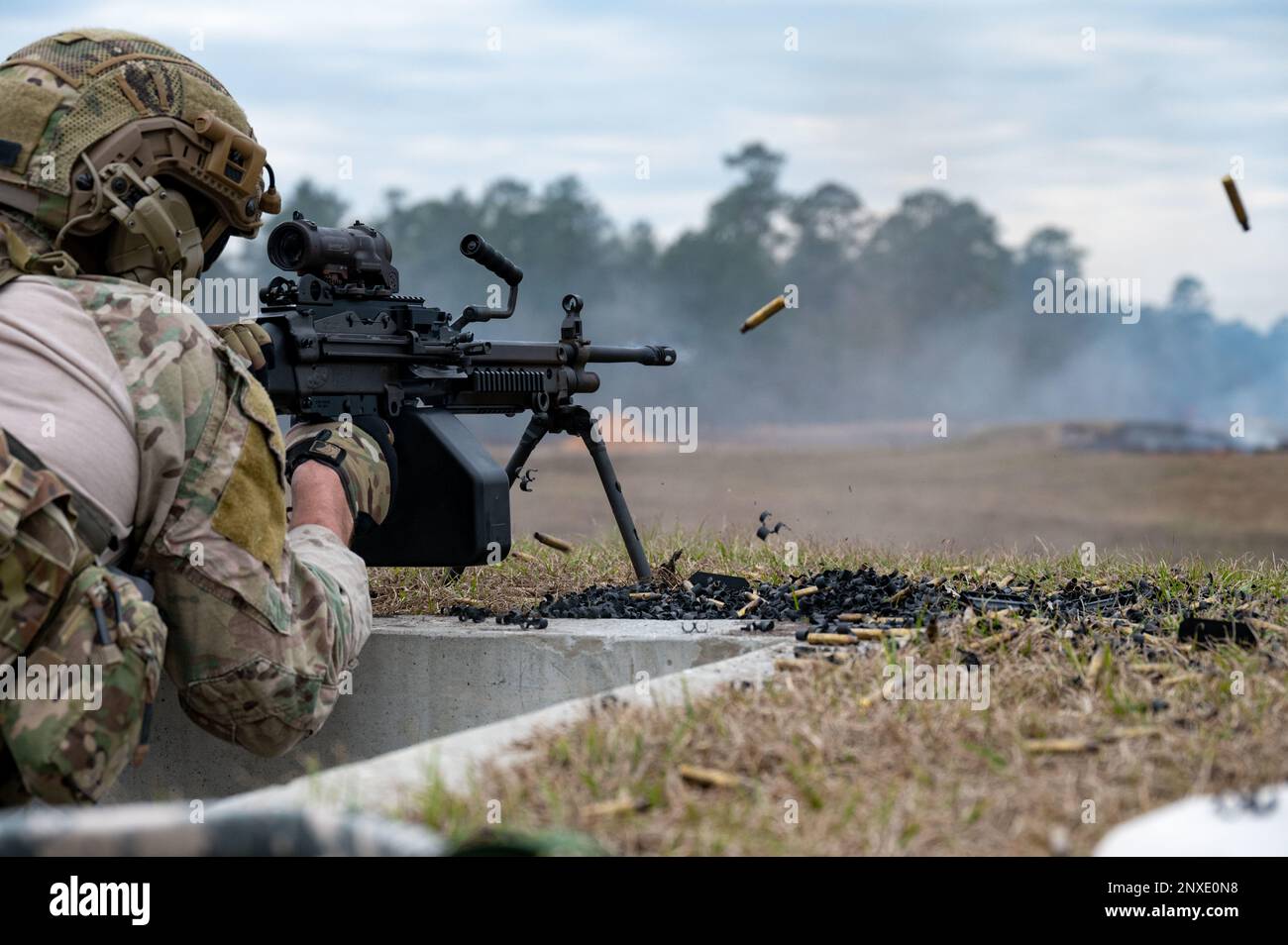 A 304th Rescue Squadron pararescueman fires an M249 squad automatic ...