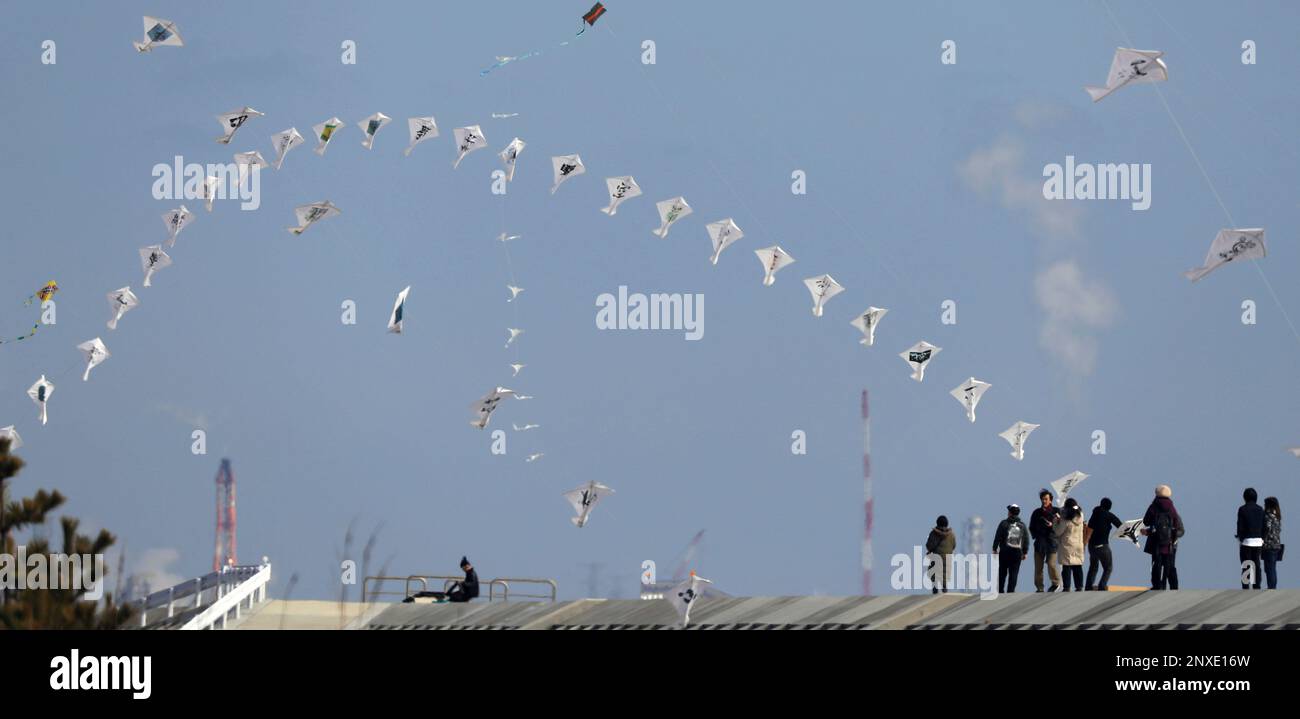 People fly kite chains to mourn the victims at Arahama beach in Sendai ...