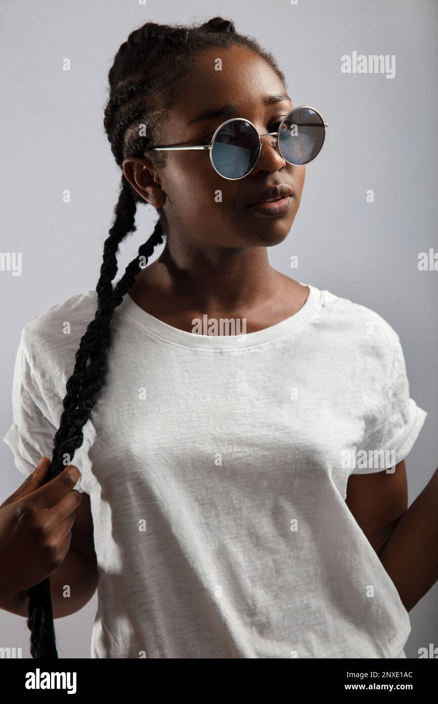 Cool Female Model With Braided Hair and Sunglasses Over Gray Background ...