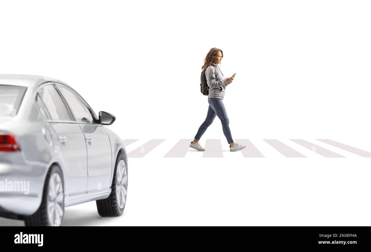 Car driving towards a pedestrian crossing and female student with a ...