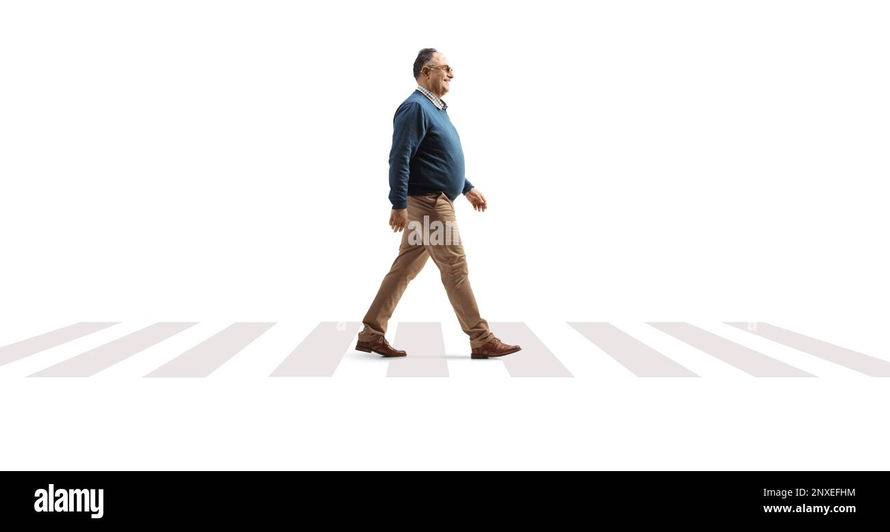 Full length profile shot of a mature man crossing street on a ...