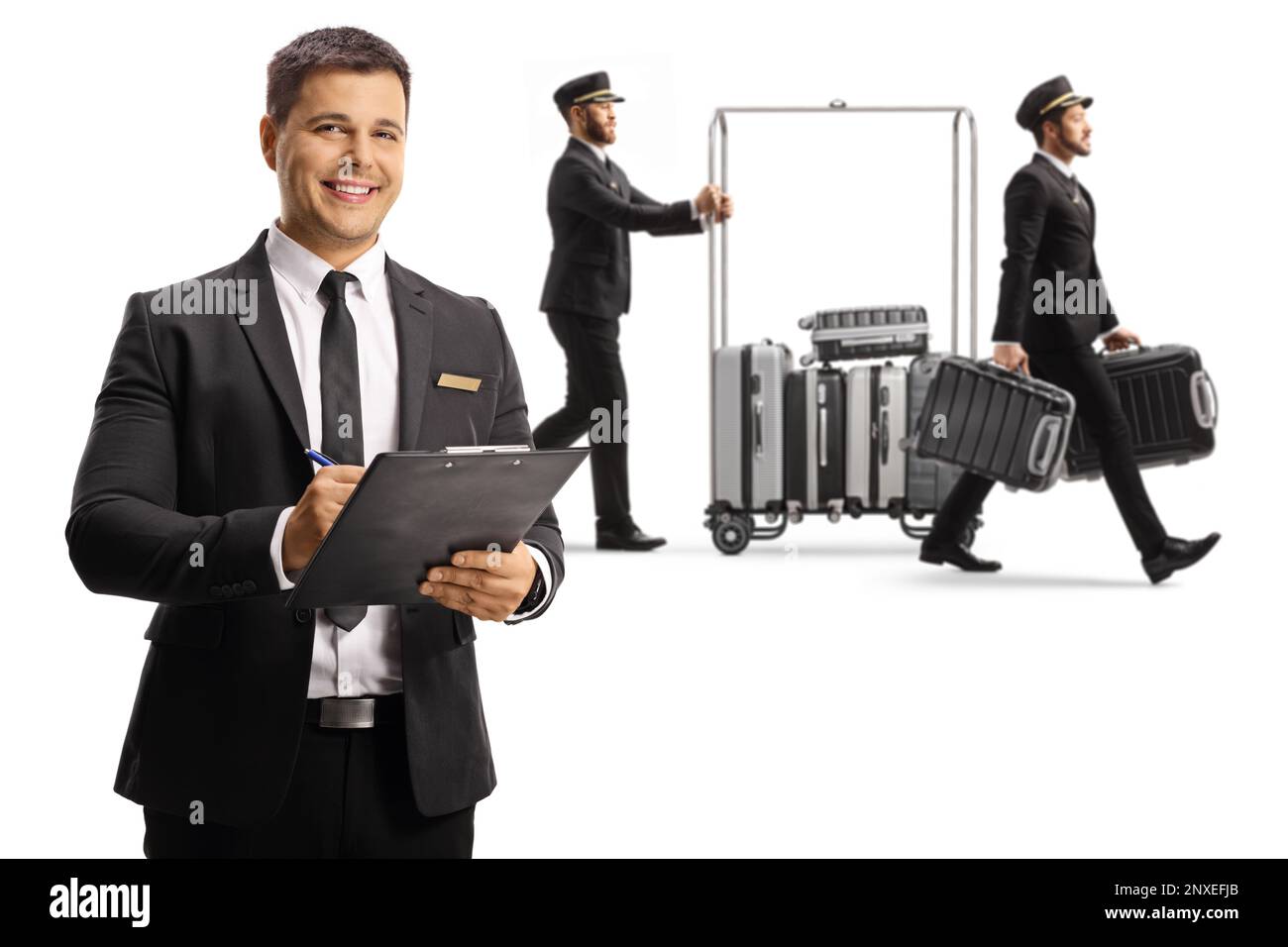 Receptionist holding a clipboard and bellboys carrying suitcases and ...