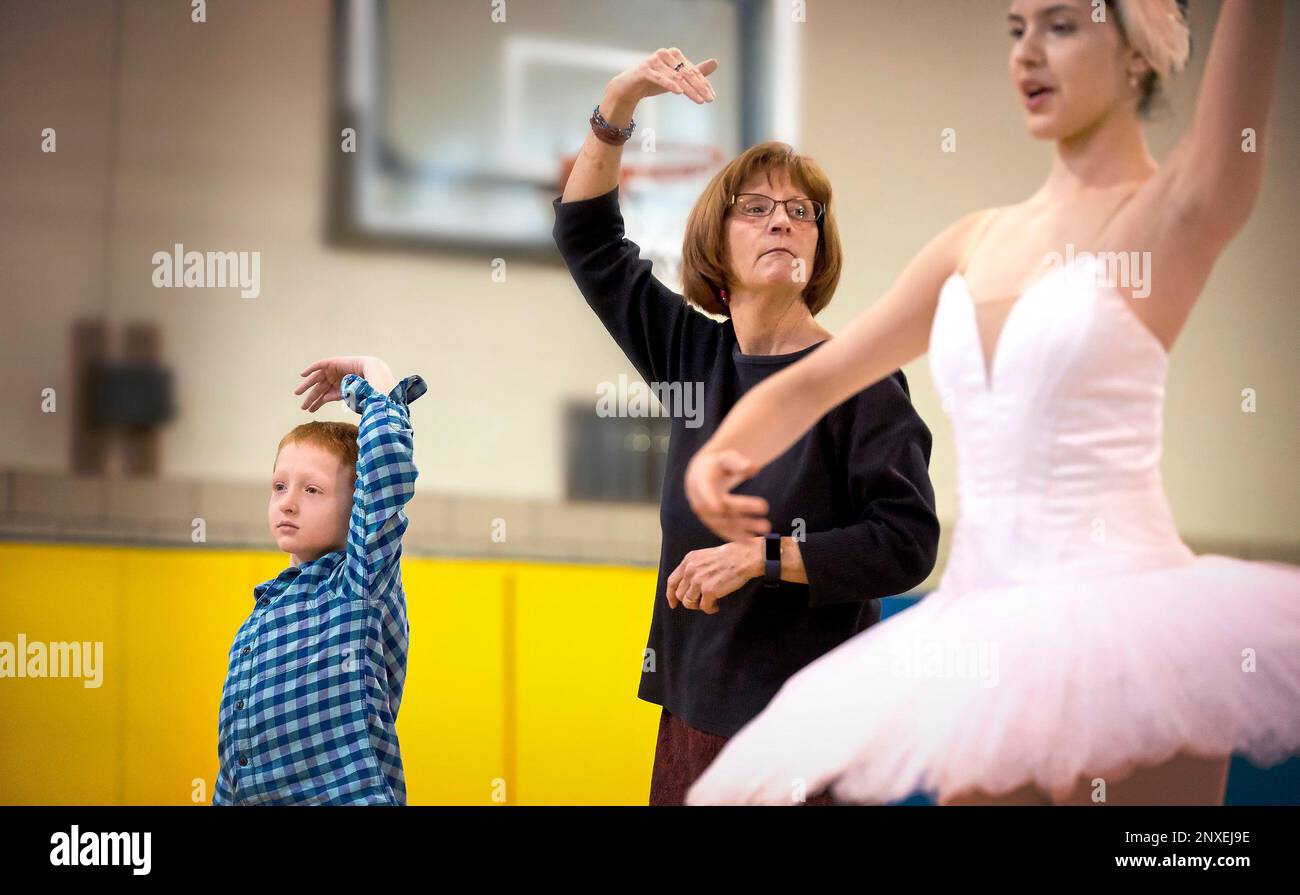 Calvin Losh, 8, and Jones Stone, staff interpreter, mimic the dancers ...