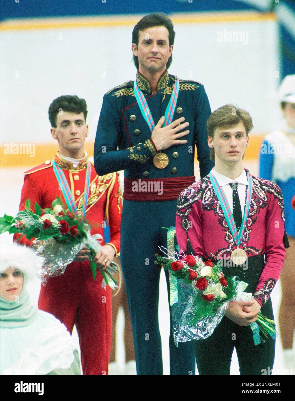 U.S. men's figure skater Brian Boitano (C) on the medals platform after ...