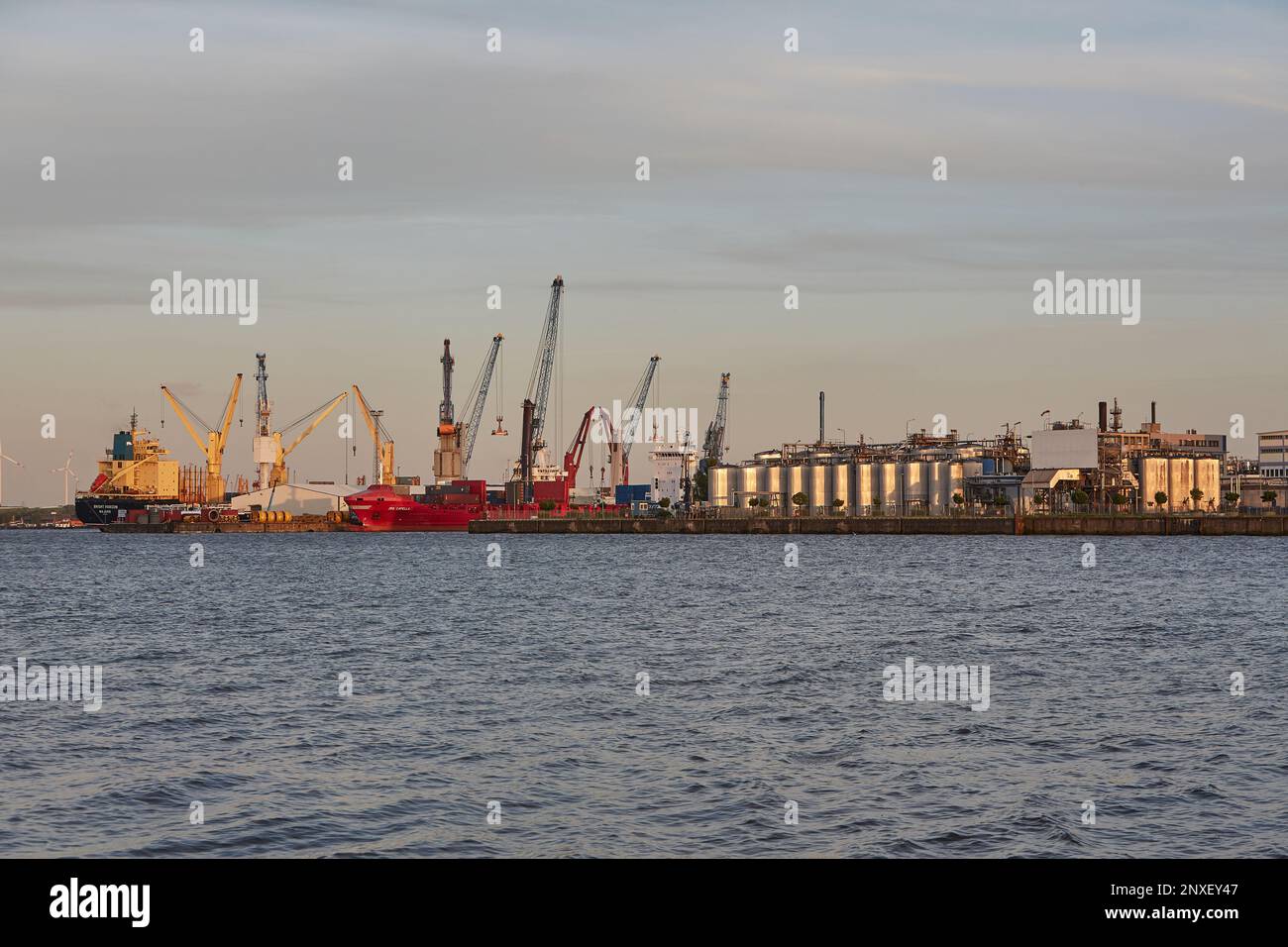 upstream view of river Elbe with container terminals, cranes, oil tanks ...