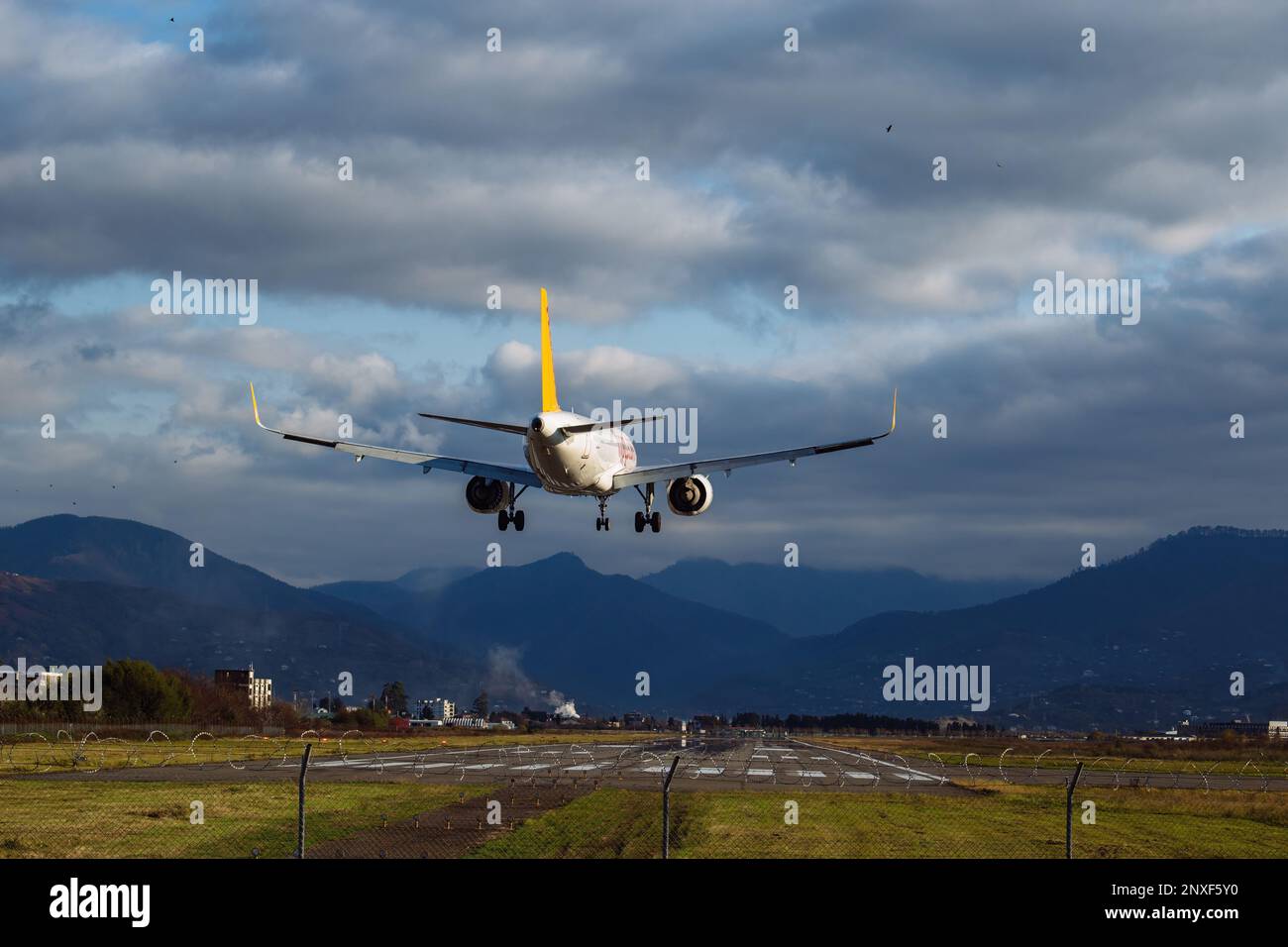 Airplane landing mountains on background hi-res stock photography and ...