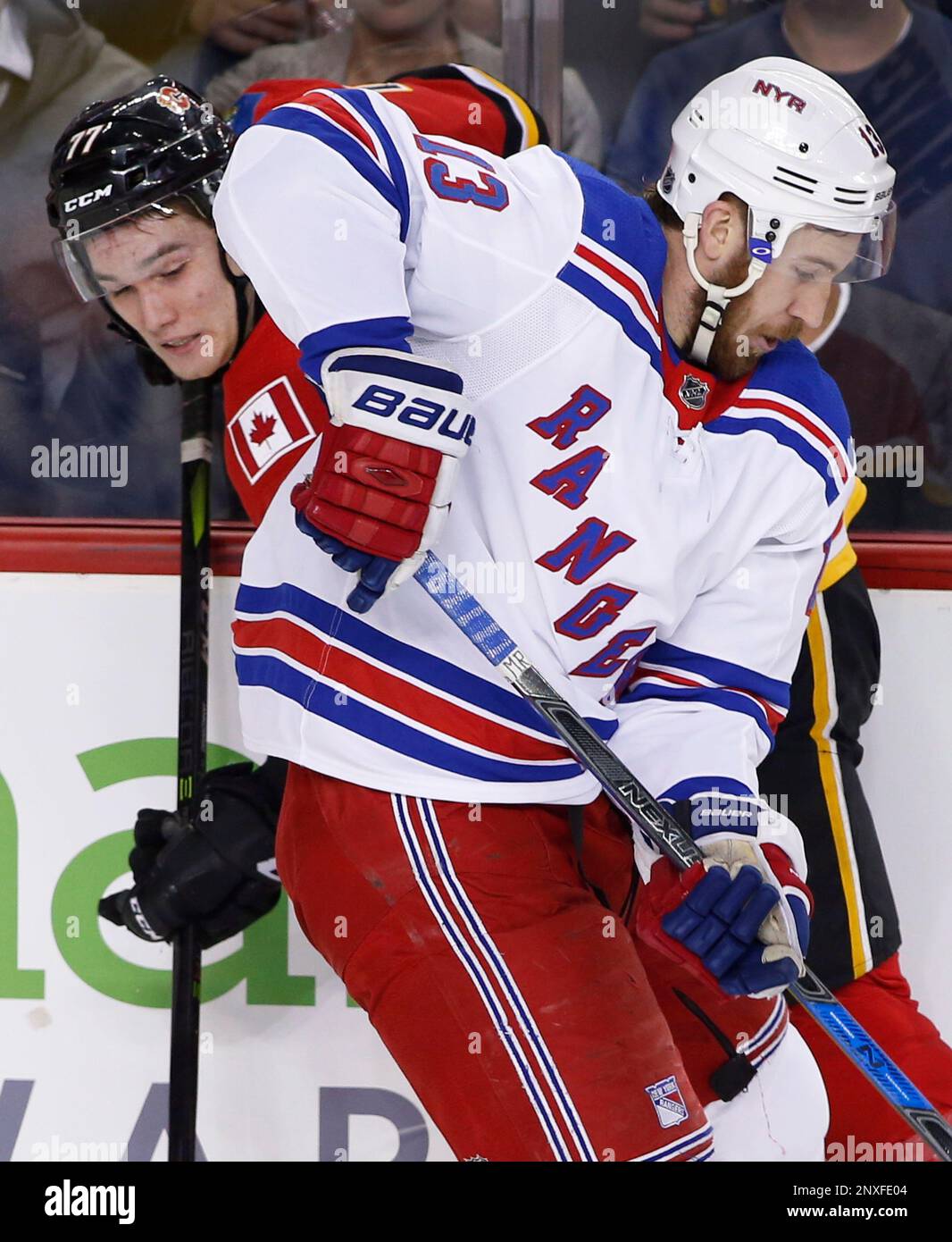 New York Rangers' Kevin Hayes, right, hits Calgary Flames' Mark ...