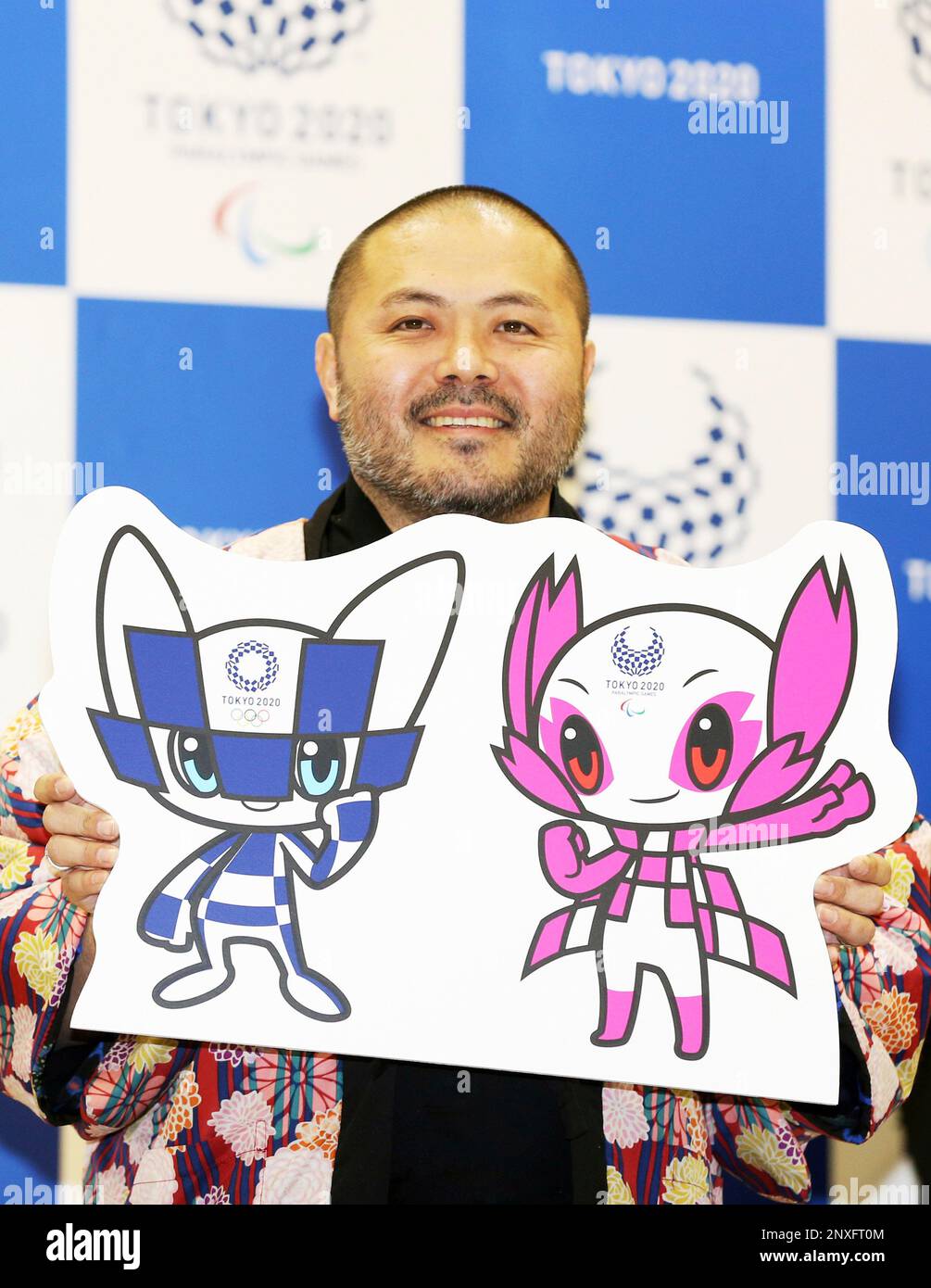 Japanese illustrator Ryo Taniguchi hilds a design of the mascots of the ...