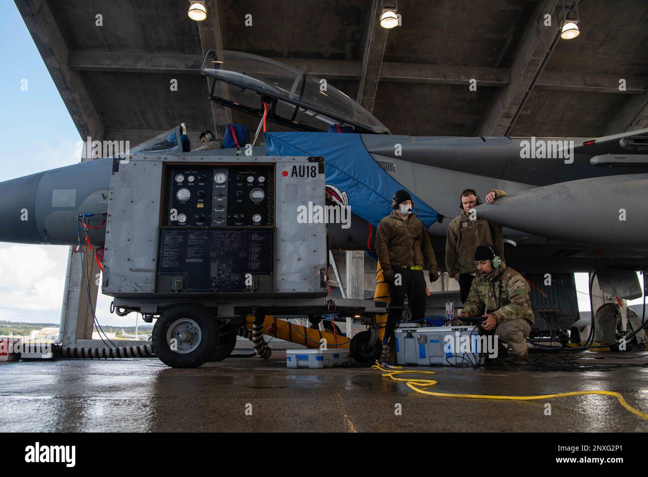 Airmen assigned to the 18th Equipment Maintenance Squadron review an F ...