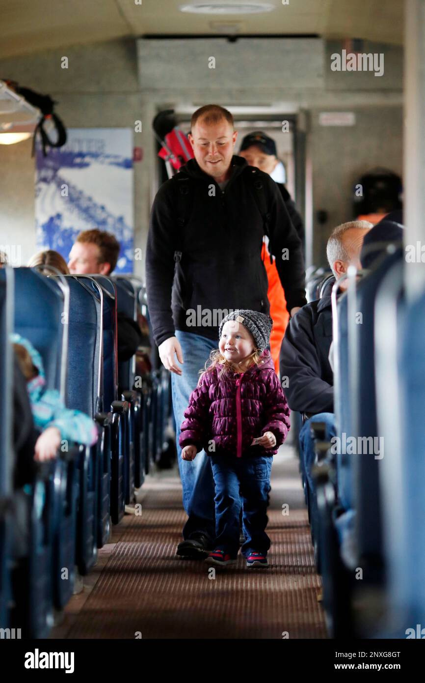 Mike Harpin and his daughter Peyton, 3, board the train adorned with ...
