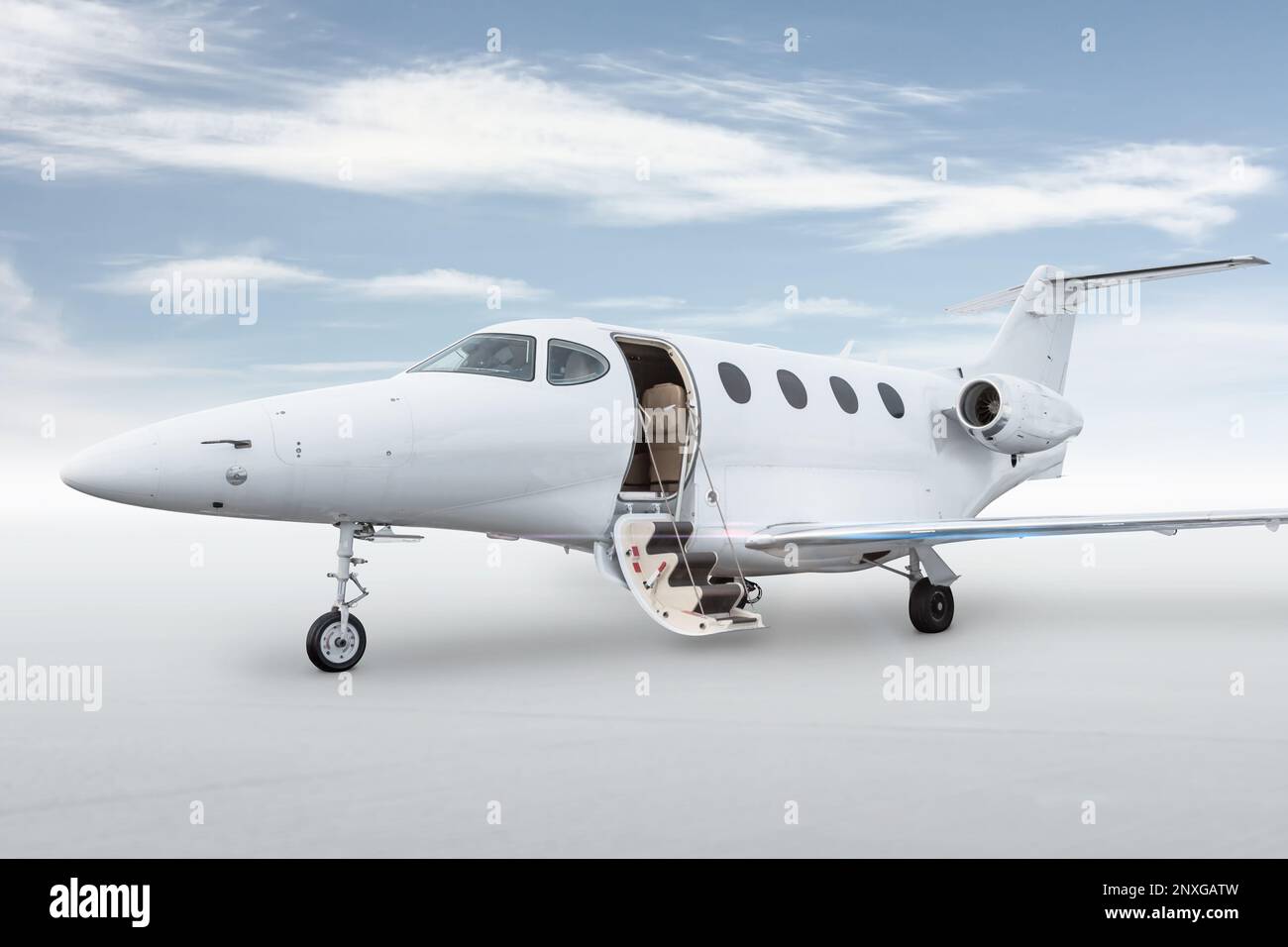 Close-up of the modern white private jet with an opened gangway door ...