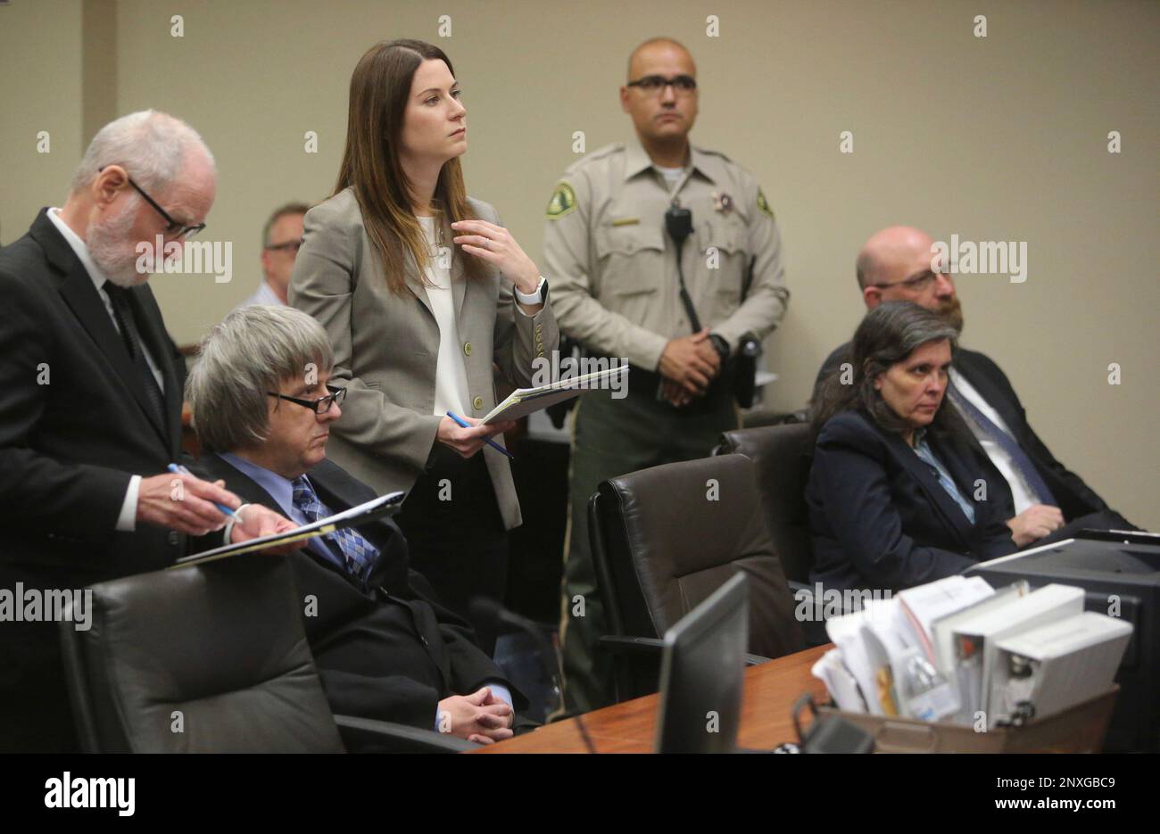 Attorneys standing David Macher, left, and Allison Lowe, appear with ...