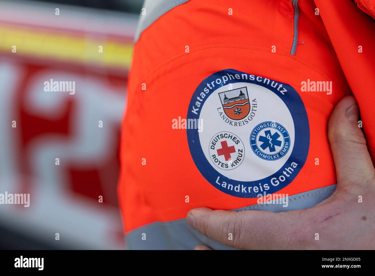 Gotha, Germany. 01st Mar, 2023. A disaster relief worker shows the logo ...